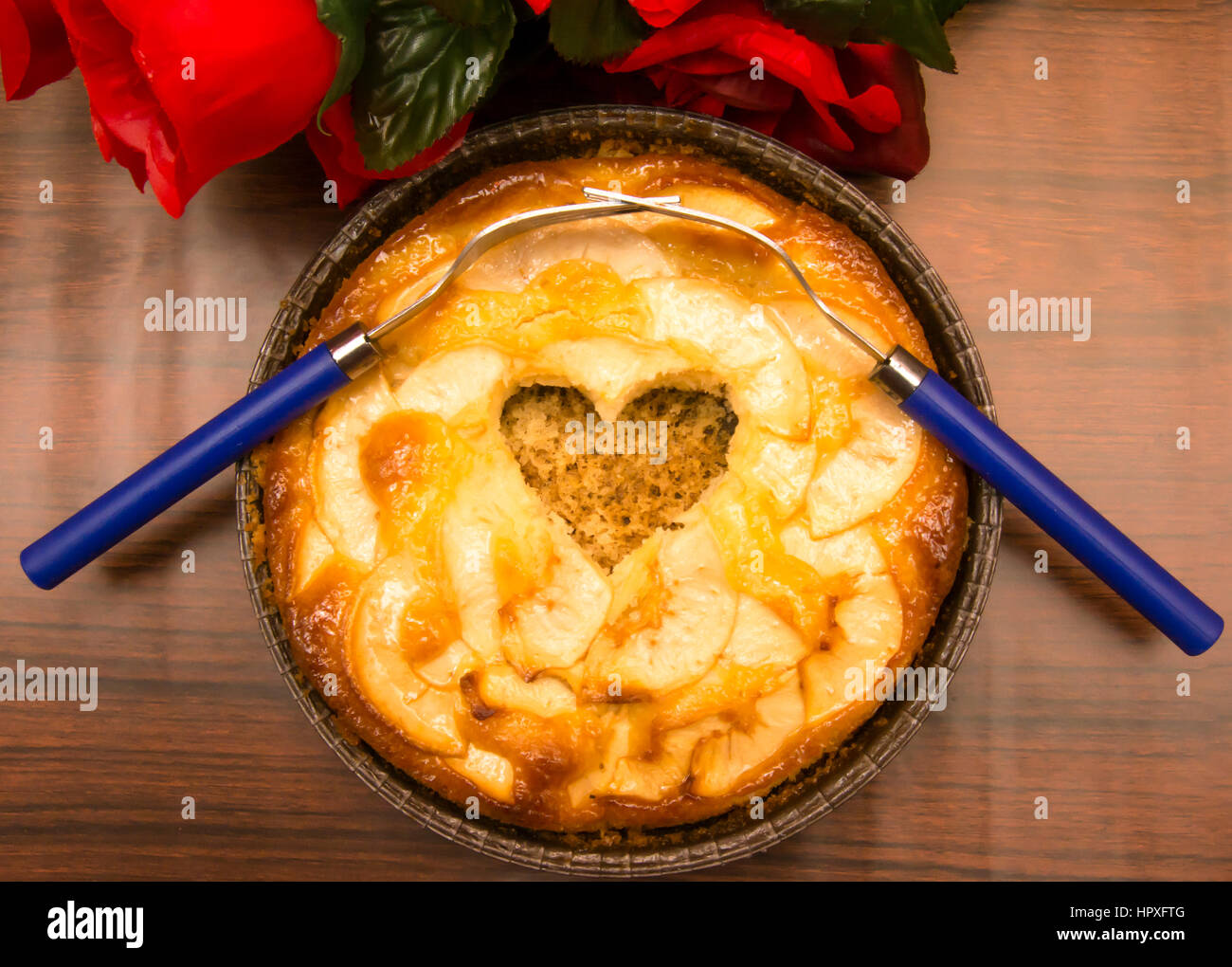 Apple pie with a hollow in the shape of a heart and two forks ...