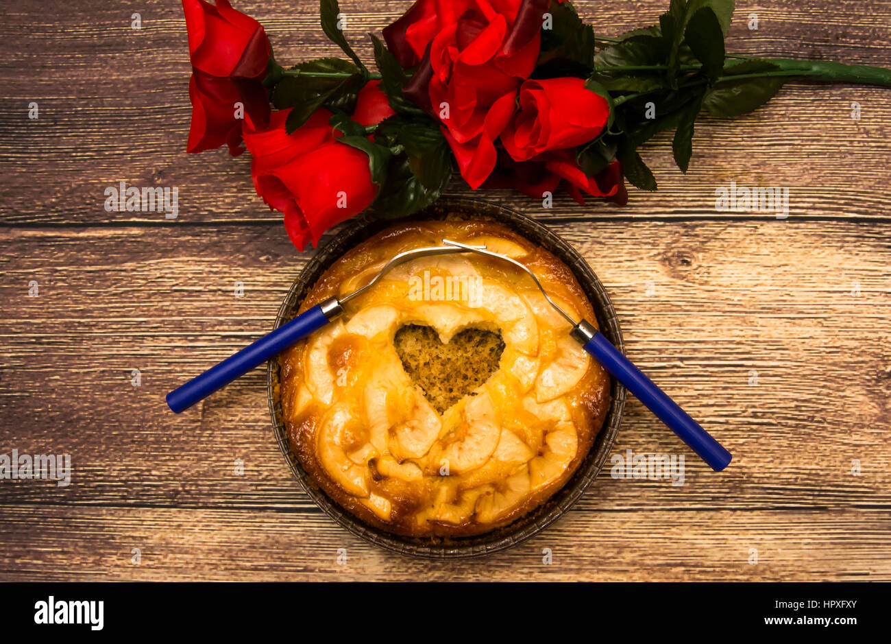 Apple pie with a hollow in the shape of a heart and two forks ...