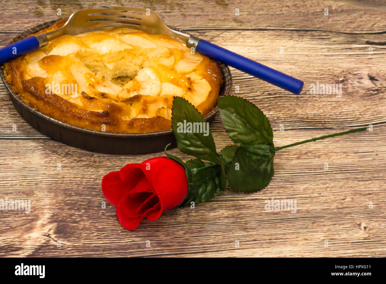 Apple pie with a hollow in the shape of a heart and two forks ...