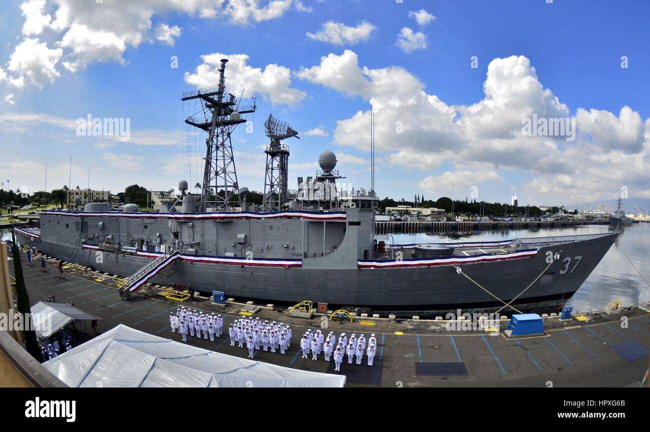 Sailors stand in formation in front of guided-missile frigate USS ...