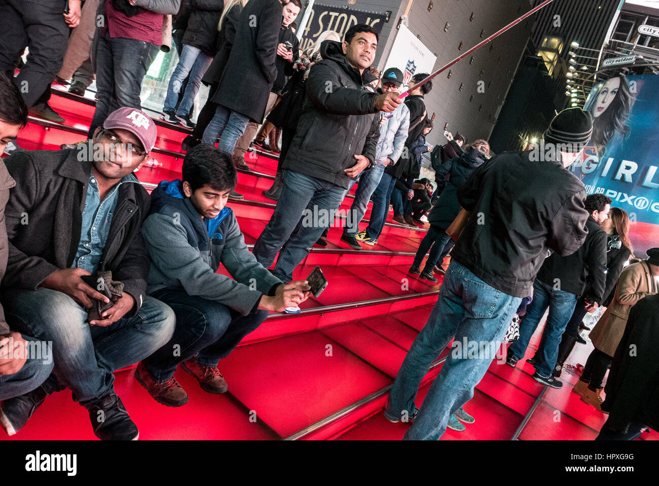 tourists posing for selfies on the red steps in times square, new york ...