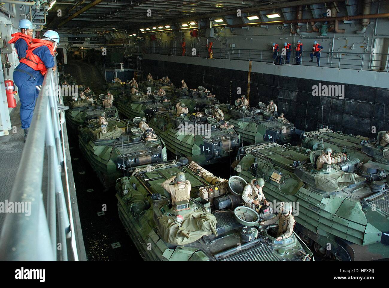 Amphibious Assault Vehicles await departure in the well deck aboard the ...