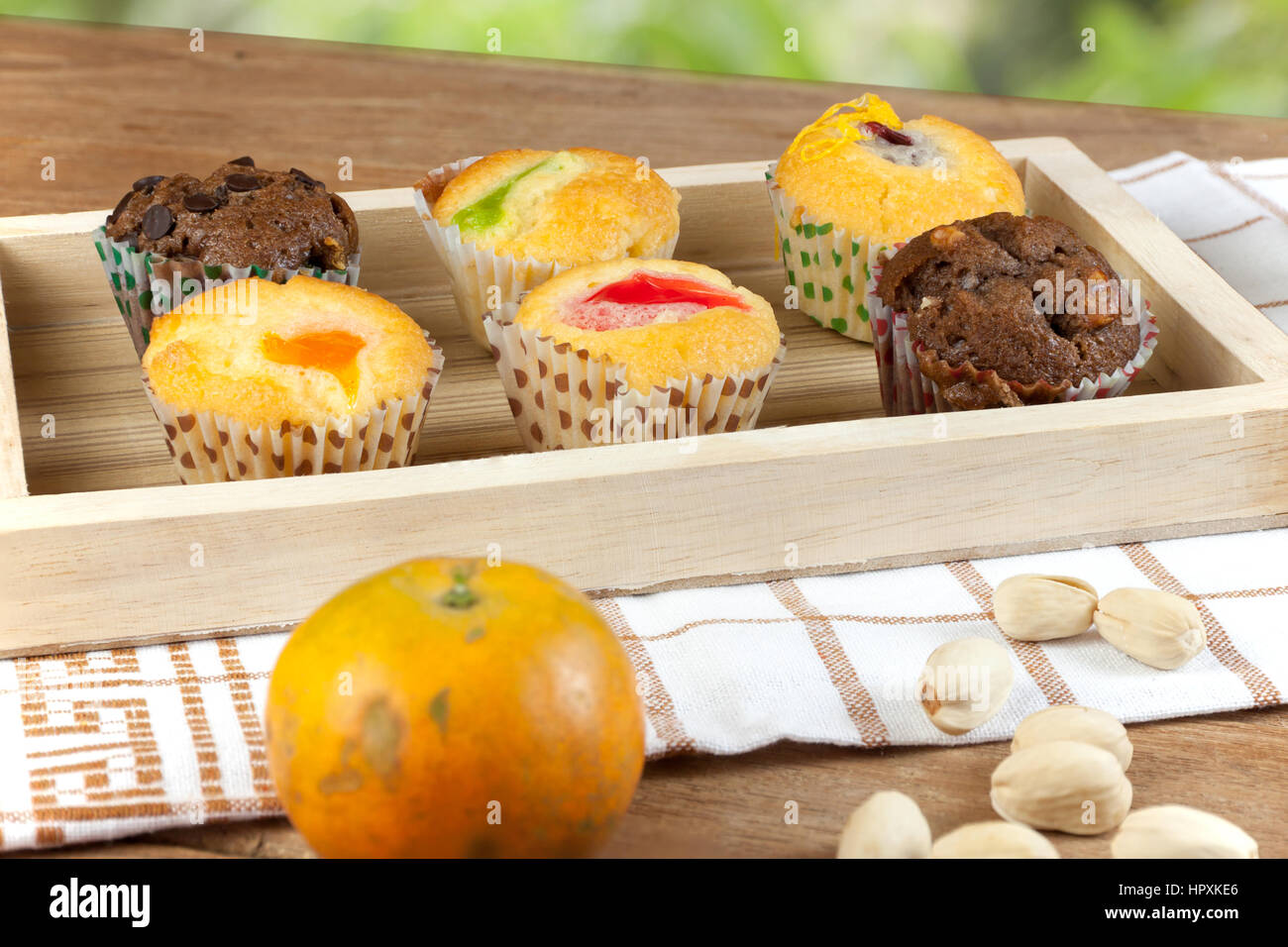 Cup cake various flavors in wood tray on wood table Stock Photo - Alamy