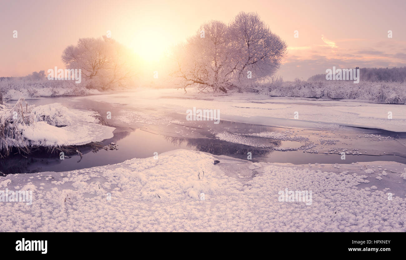 Sun rising above icy lake. Ice pattern on lake. Bright Christmas ...
