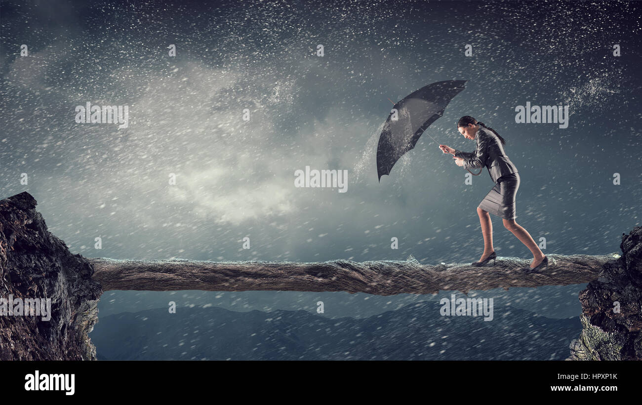 Businesswoman with umbrella walking against strong wind. Mixed media ...