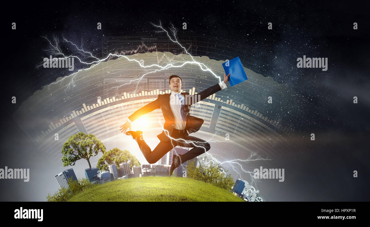 Young excited businessman jumping or dancing to celebrate his success ...