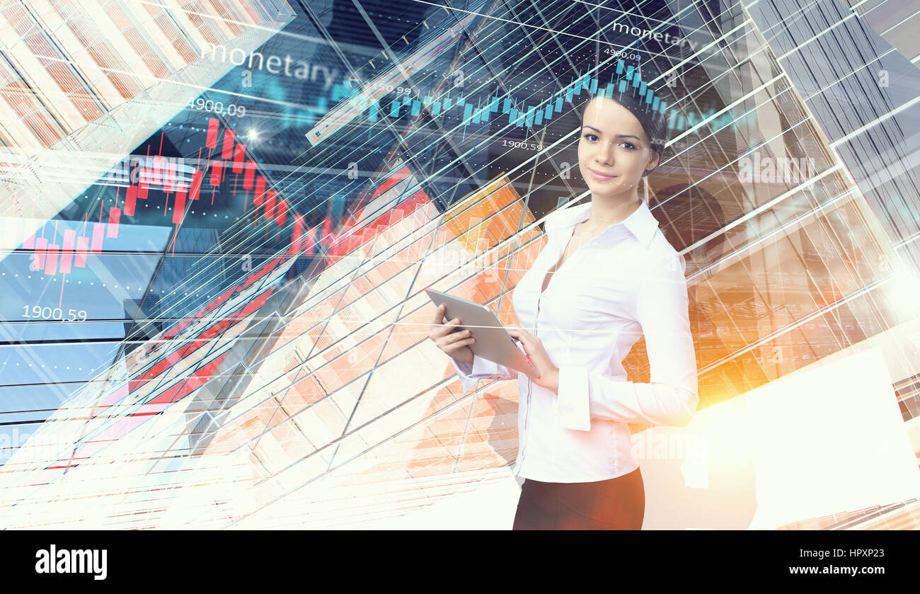 Attractive businesswoman using tablet pc against modern city background ...