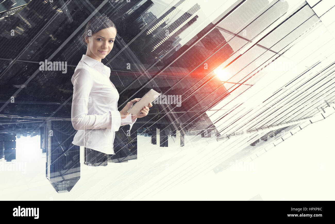 Attractive businesswoman using tablet pc against modern city background ...