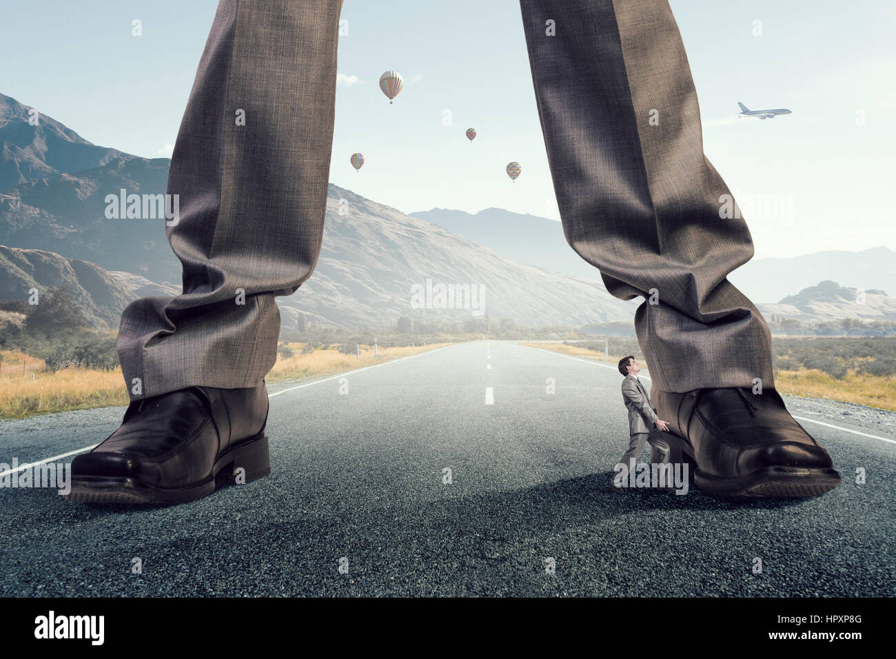 Bottom view of giant businessman as concept of power and leadership ...