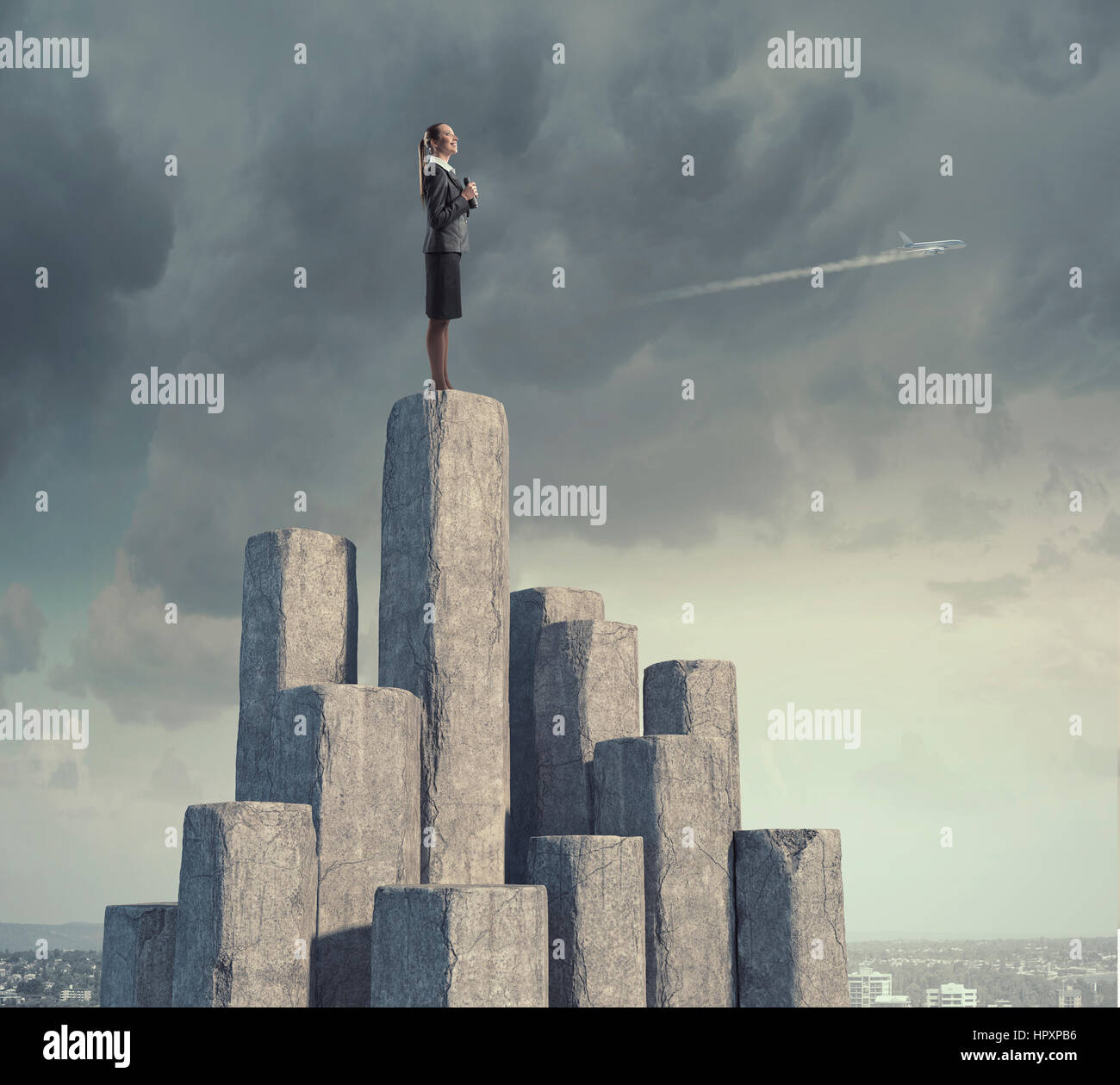 Businesswoman in suit with briefcase on stone column peak. Mixed media ...