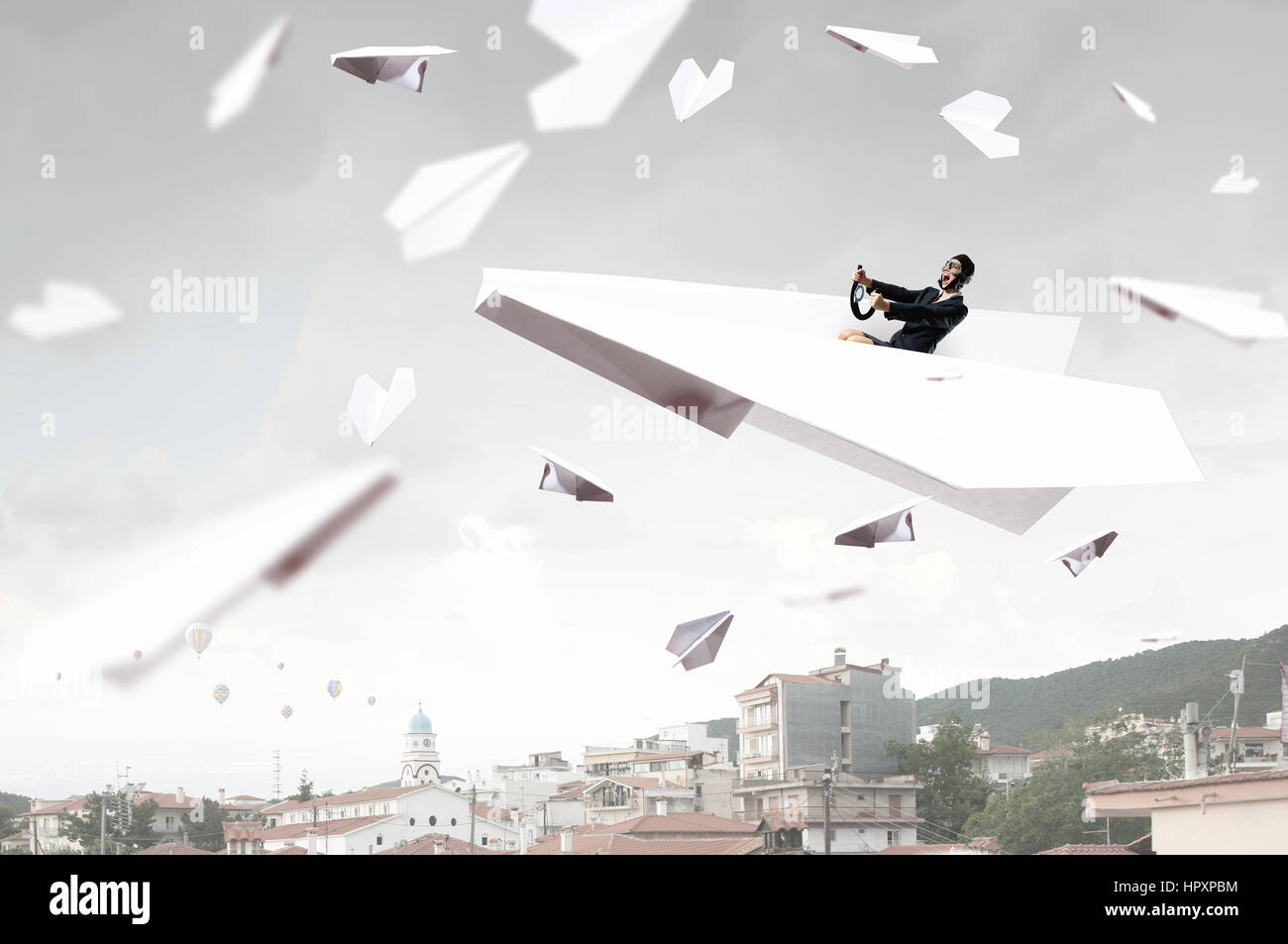 Young cheerful pilot woman flying in paper plane Stock Photo - Alamy