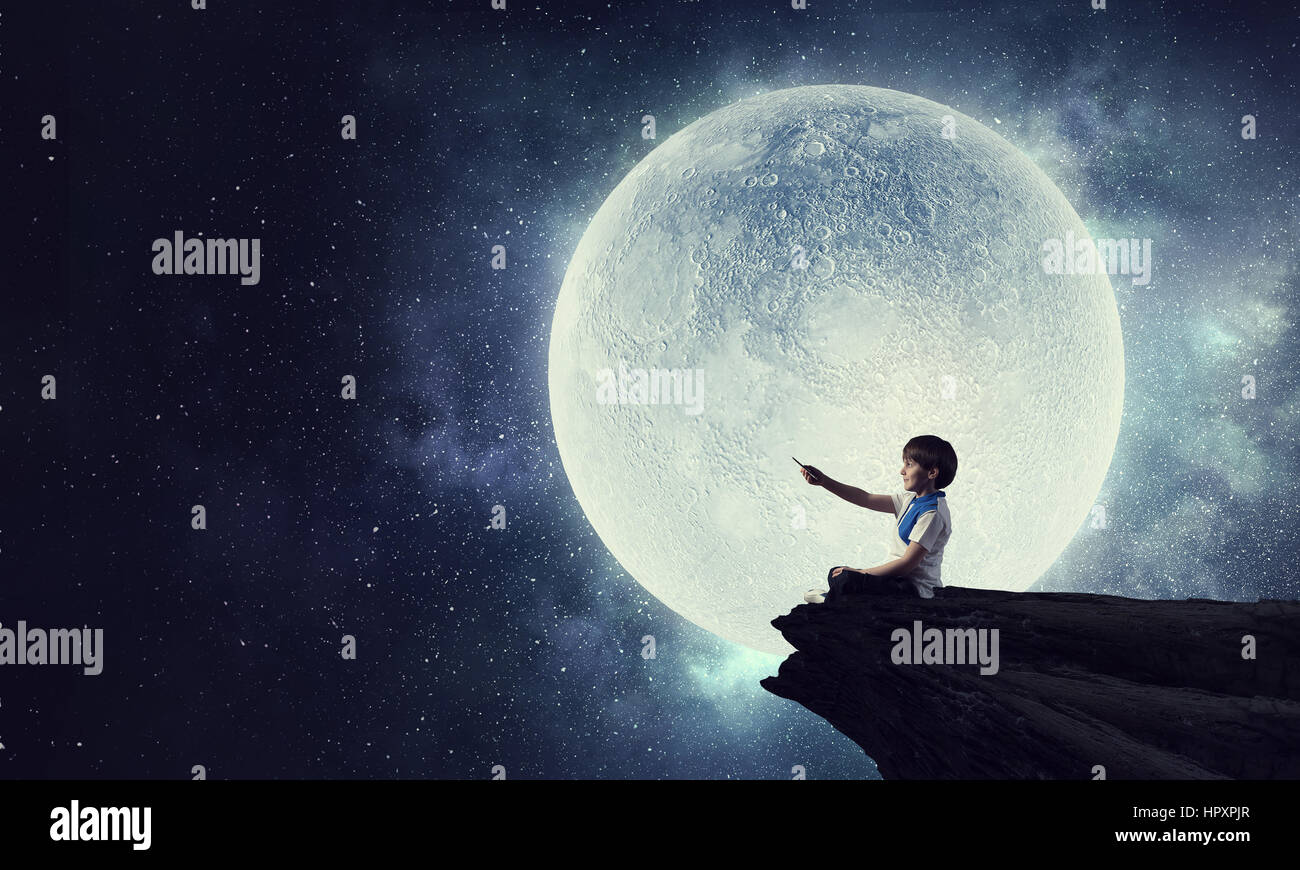 Silhouette of kid boy against moon planet in night sky Stock Photo - Alamy