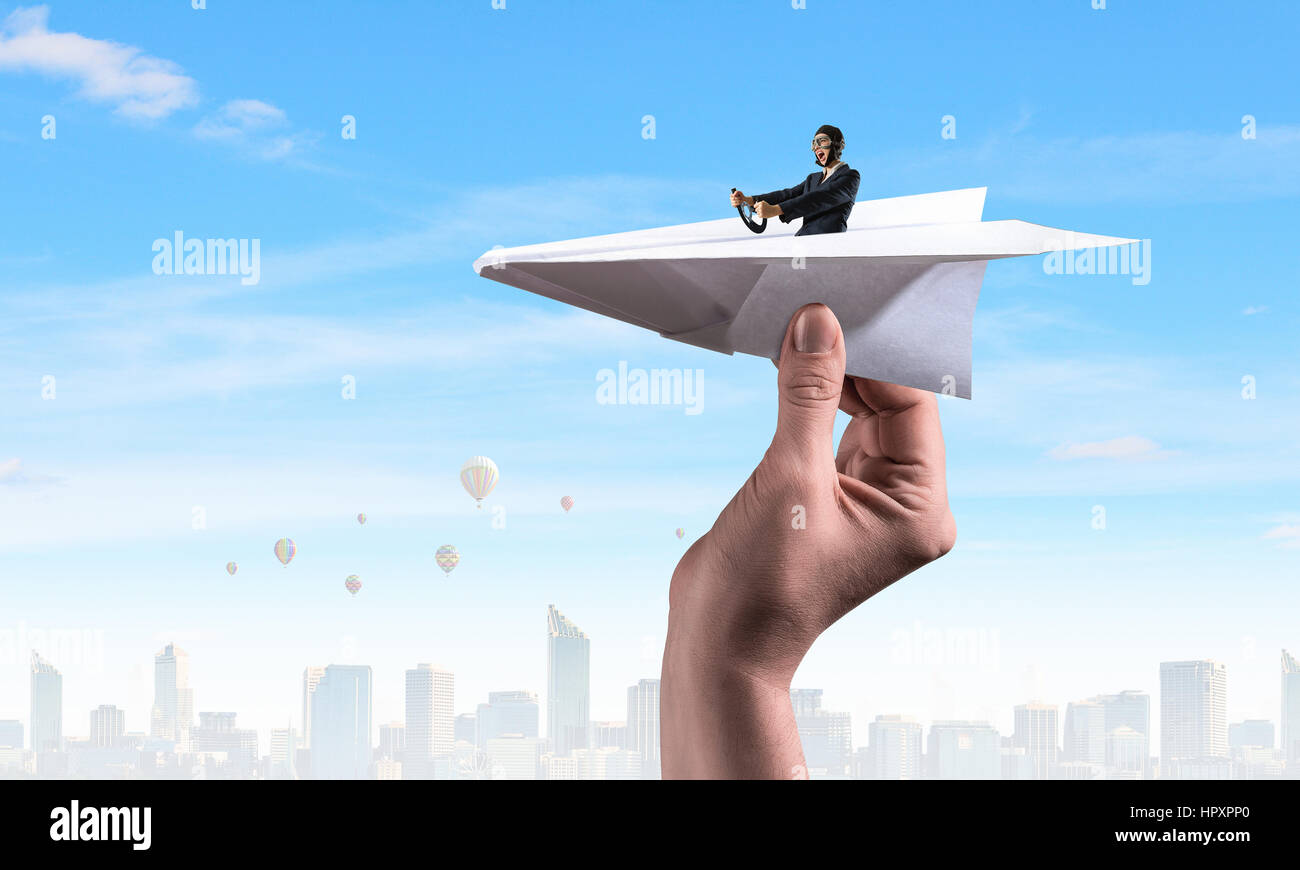 Young cheerful pilot woman flying in paper plane Stock Photo - Alamy