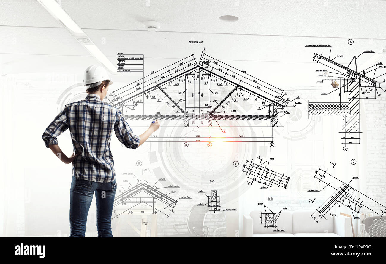 Rear view of engineer woman drawing construction plan Stock Photo - Alamy