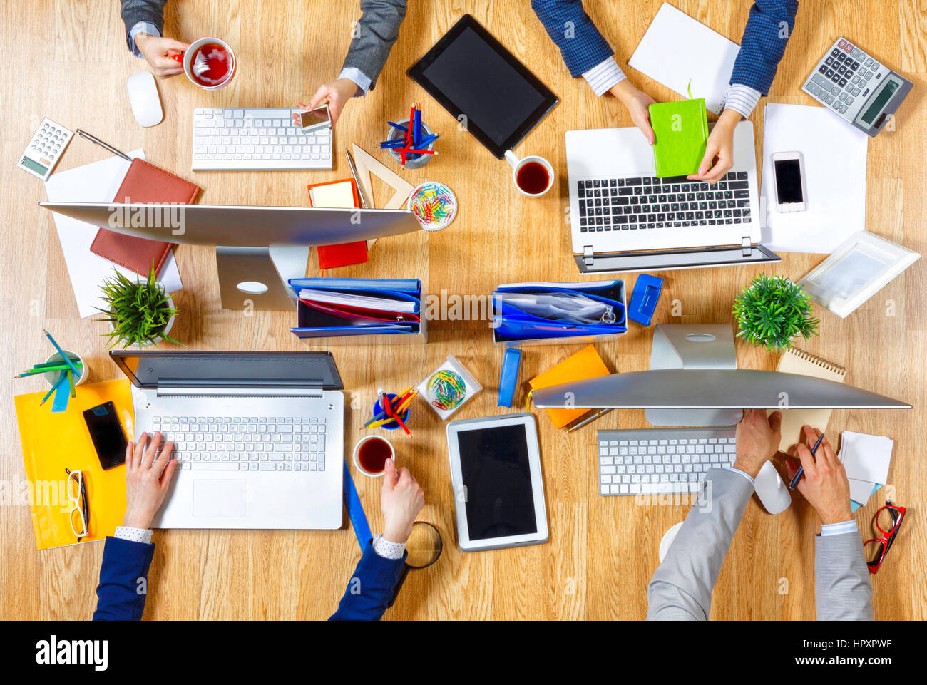 Top view of office table with four colleagues working together Stock ...