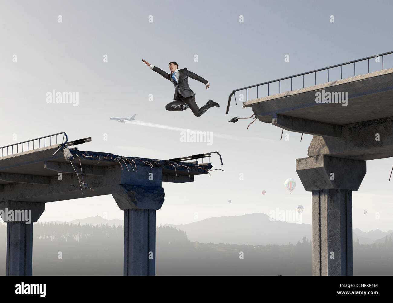 Businessman jumping over a gap in bridge as symbol of problem ...