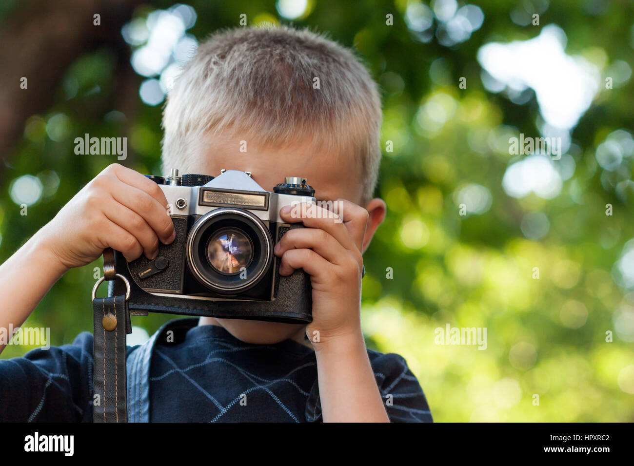 Cute little happy boy with vintage photo camera outdoors Stock Photo ...
