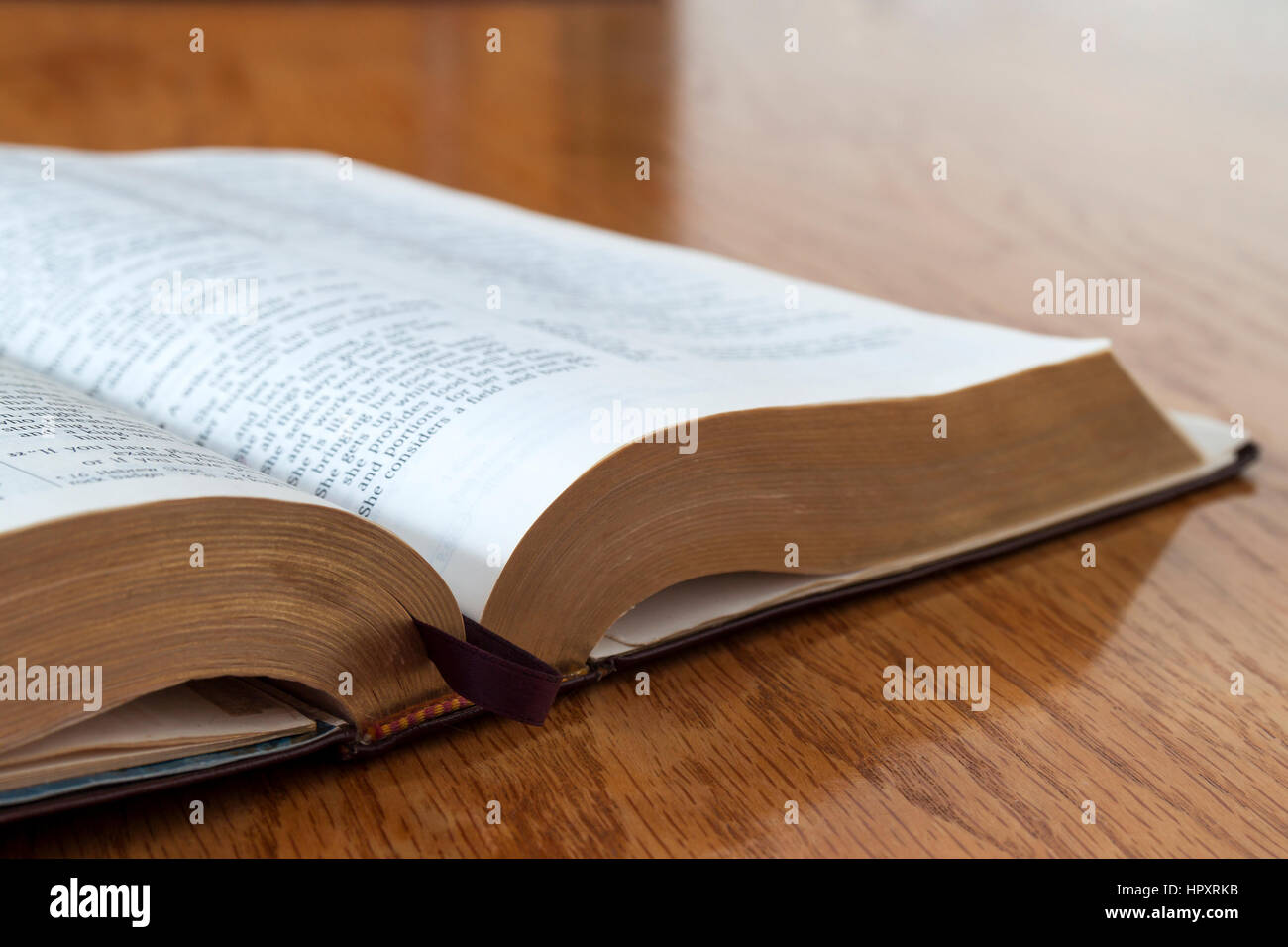 Open book Holy Bible on yellow wooden background Stock Photo - Alamy