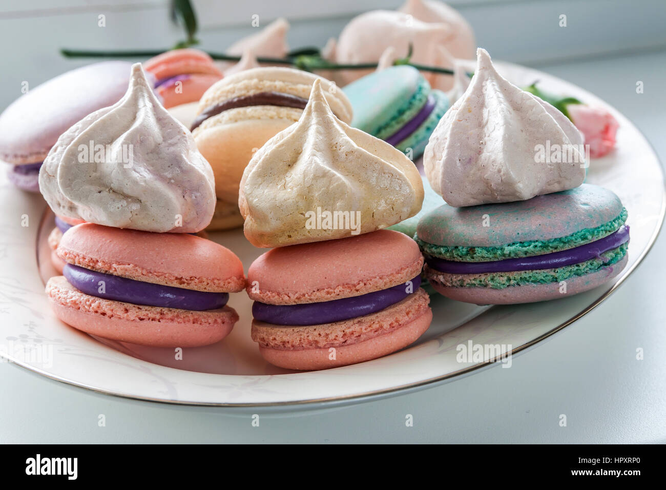 Sweet and colorful french macaroons or macaron in ceramic white plate ...