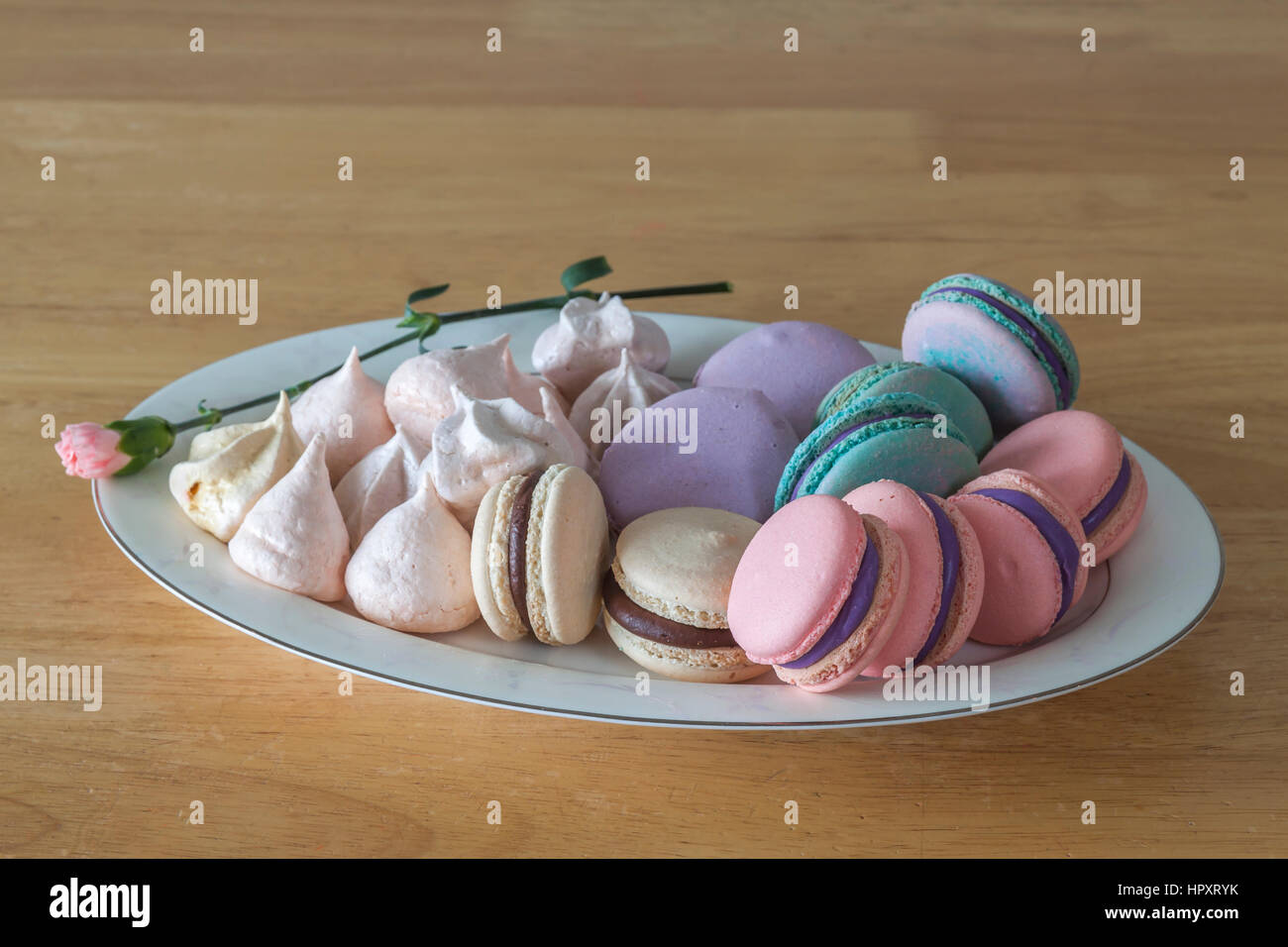 Sweet and colorful french macaroons or macaron in ceramic white plate ...