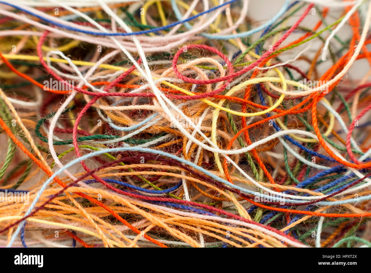 Multi-colored tangled colorful needlecraft silk thread rope. Macro shot ...