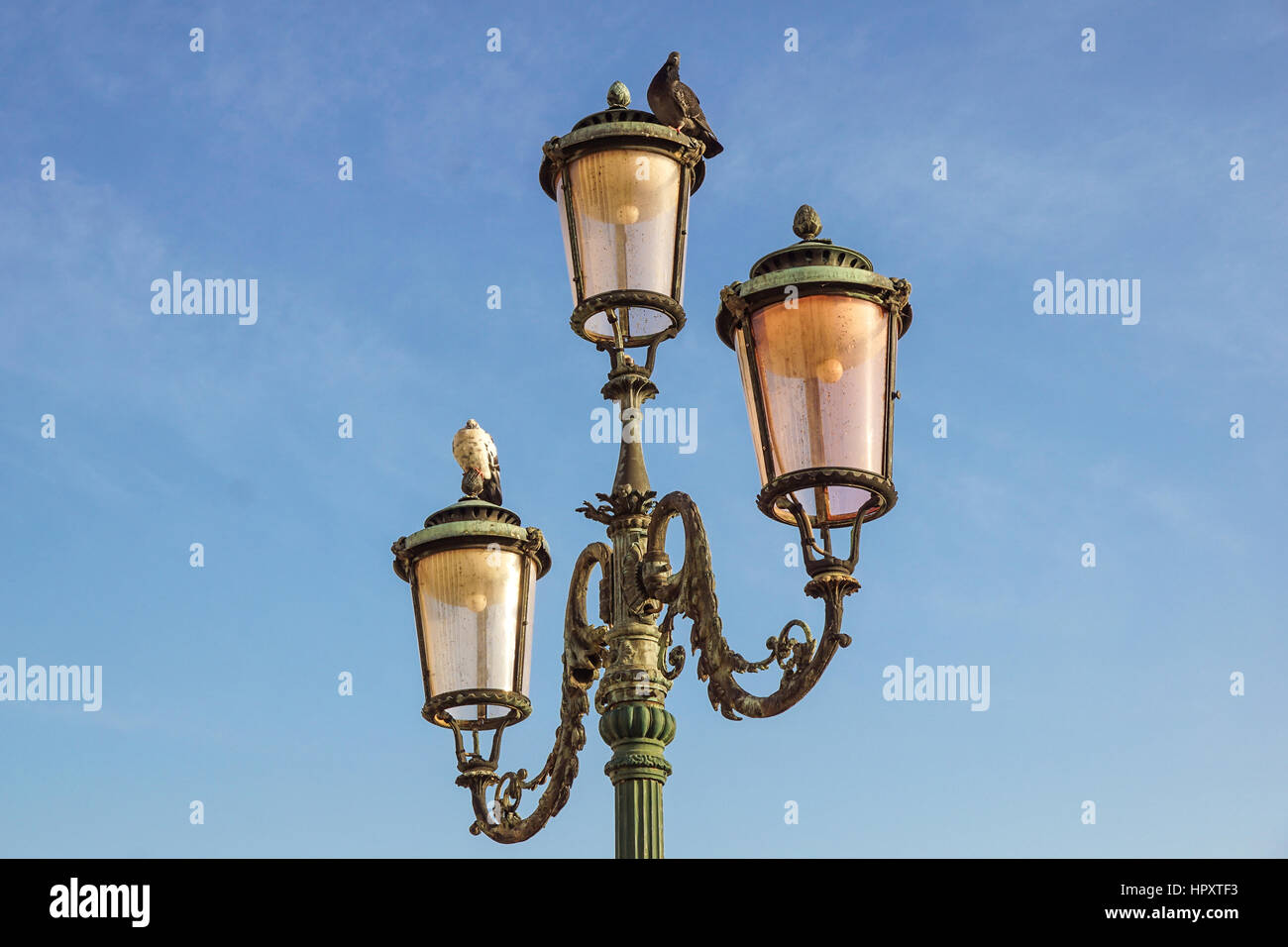 Classic old lamp post isolated on a blue sky background close up Stock ...