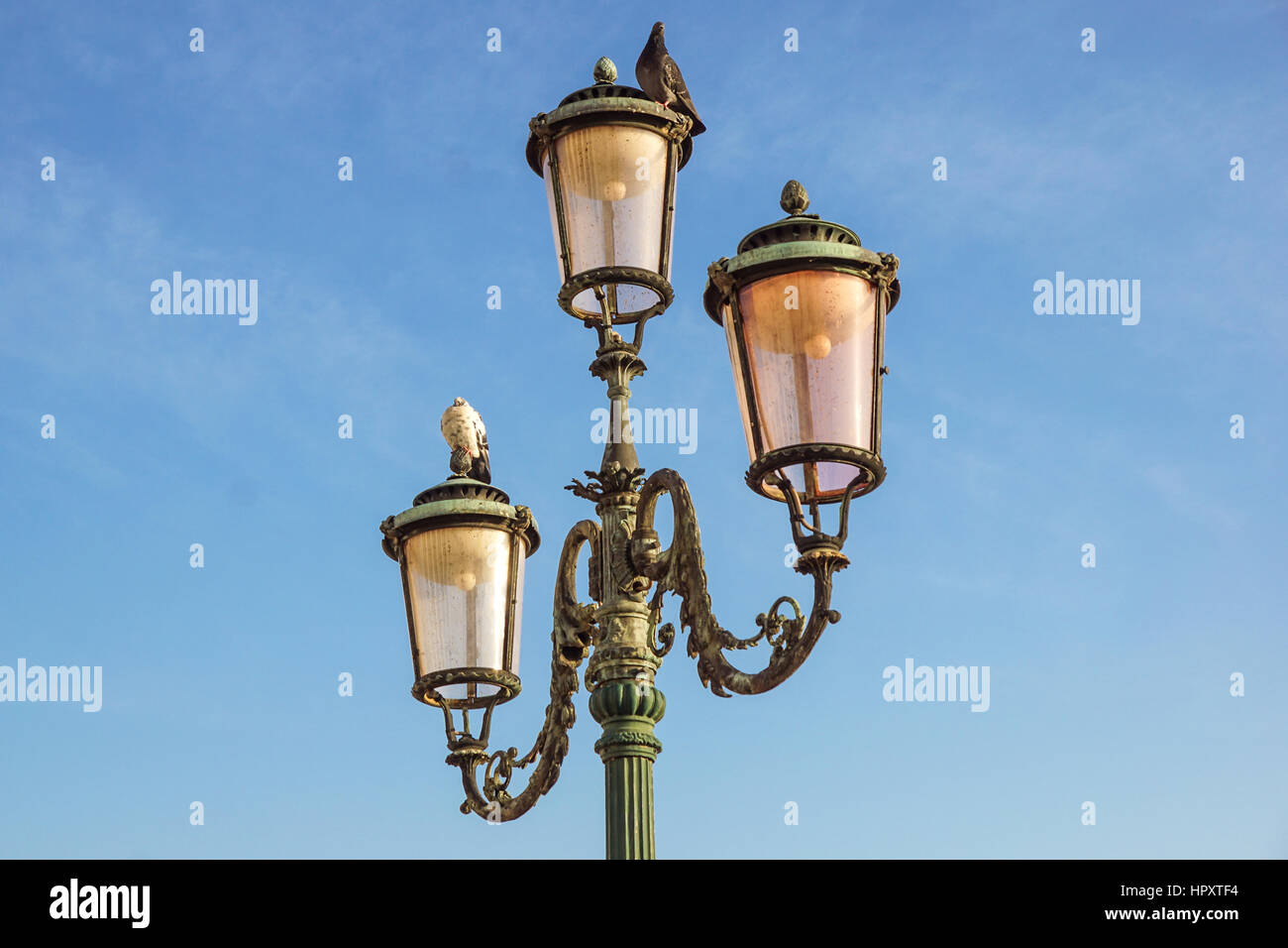 Classic old lamp post isolated on a blue sky background close up Stock ...