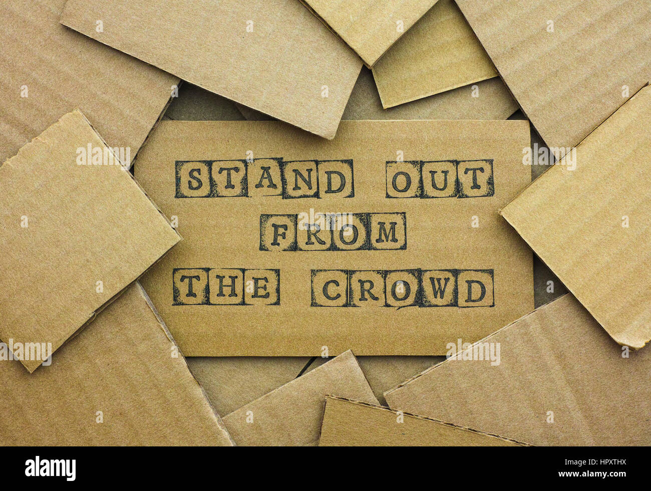 Words Stand Out From The Crowd make by black alphabet stamps on ...