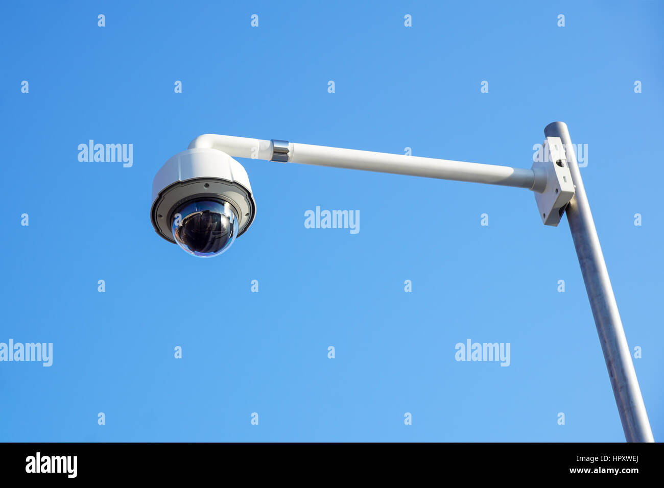 High tech overhead security camera with blue sky Stock Photo - Alamy