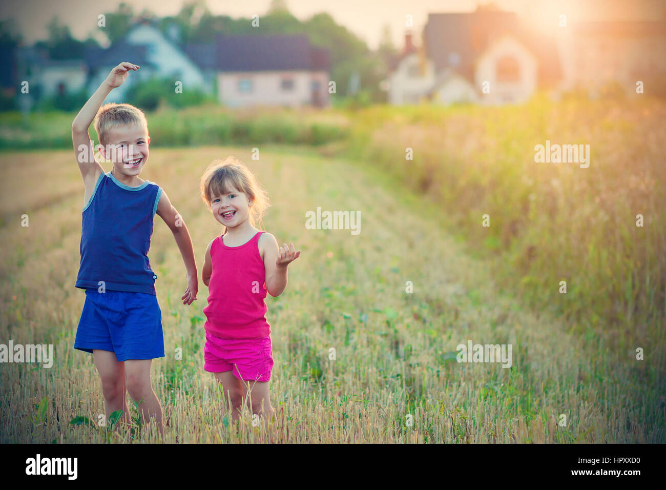 Two happy joyful merry children boy and girl brother and sister ...