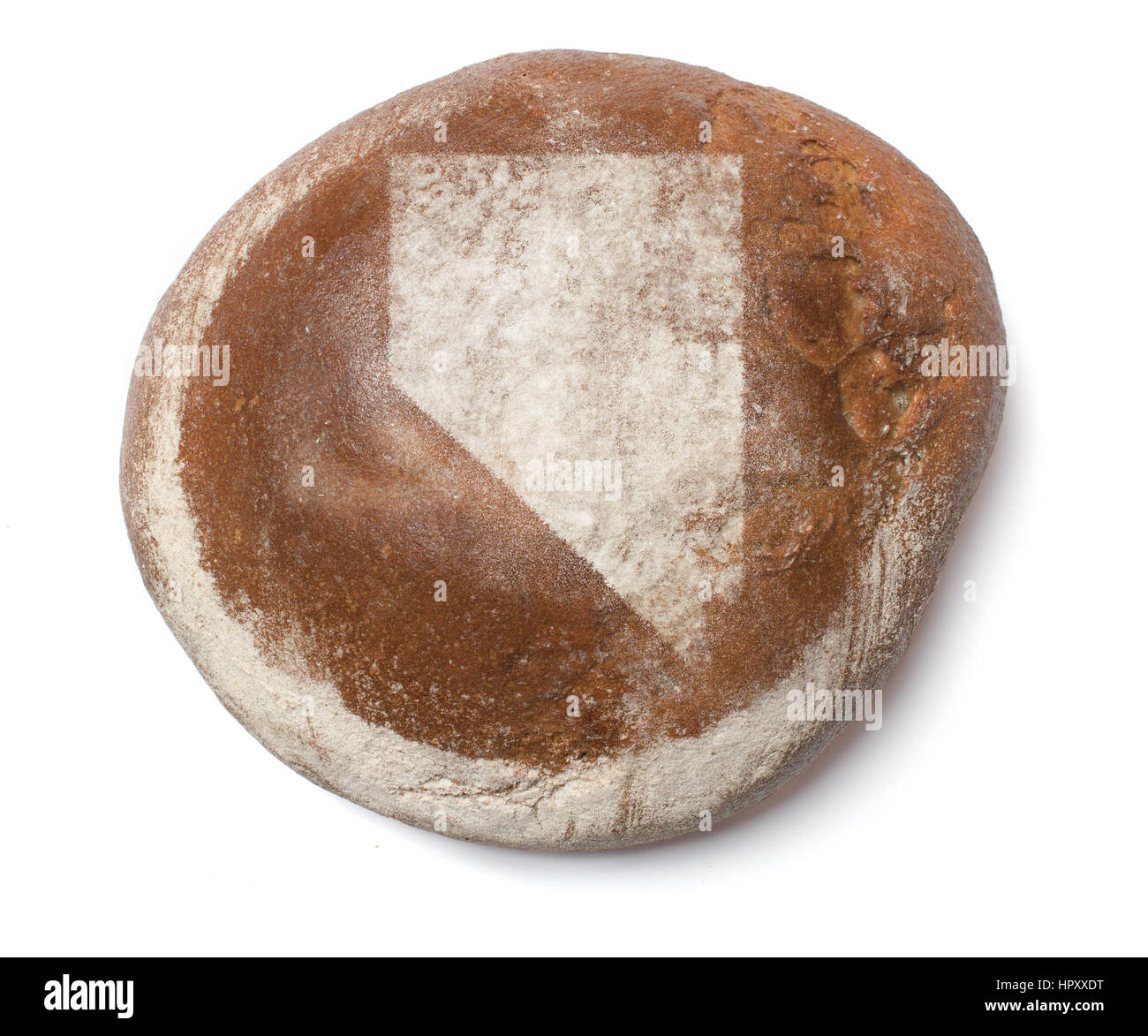A freshly baked loaf of bread covered with rye flour in the shape of ...