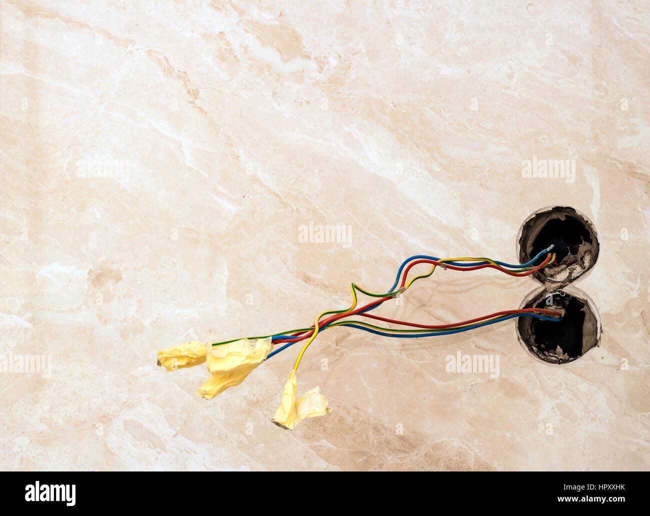 Finishing works at renovated apartment. Electrical wiring installation ...