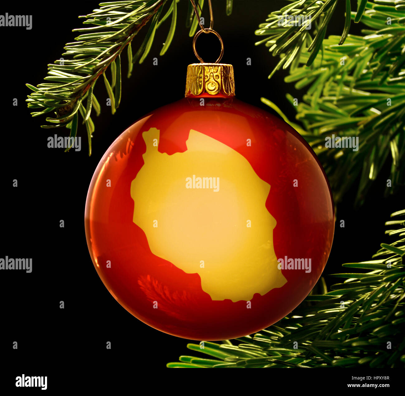 A red bauble with the golden shape of Tanzania hanging on a christmas ...