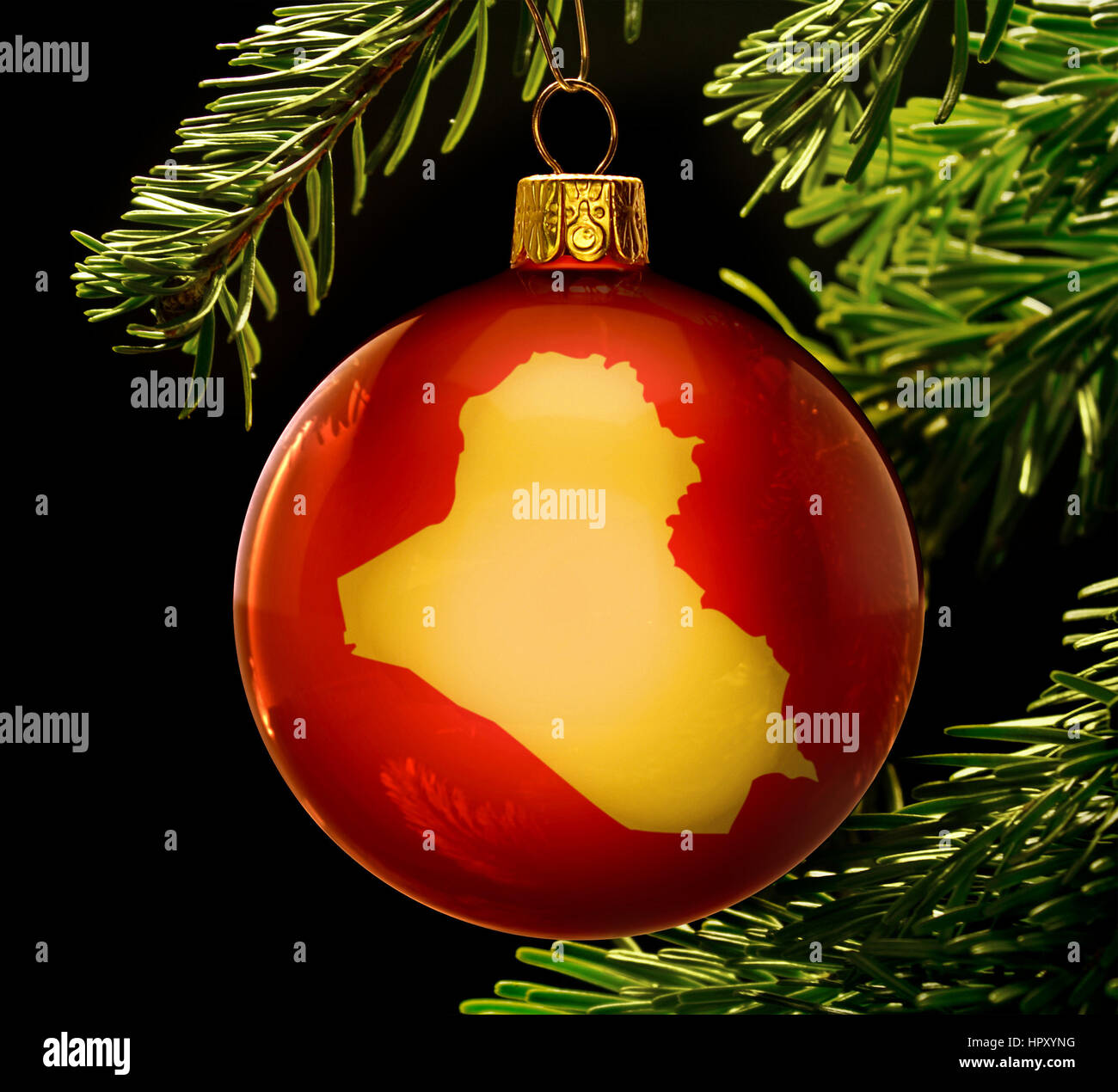A red bauble with the golden shape of Iraq hanging on a christmas tree ...