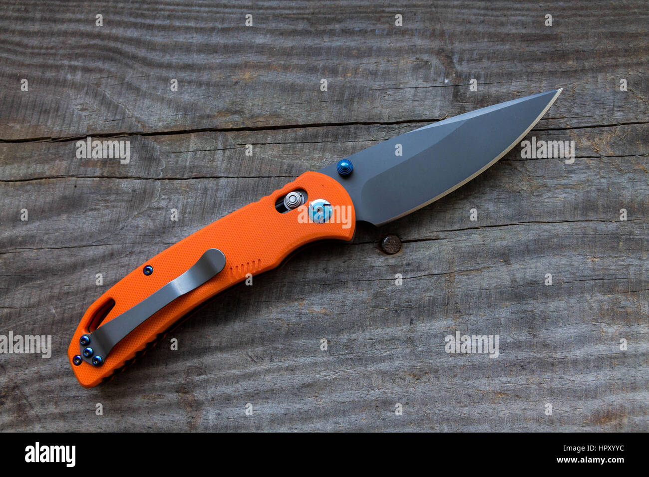 Knife with a clip. Pocket knife. Orange knife Stock Photo - Alamy