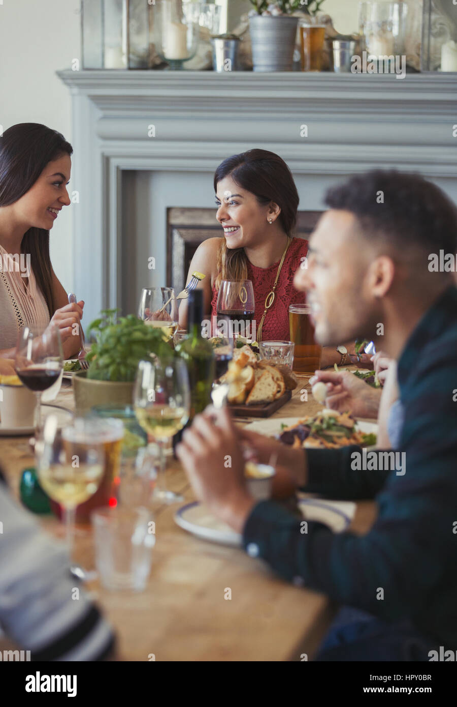 Smiling women friends talking and dining at restaurant table Stock ...