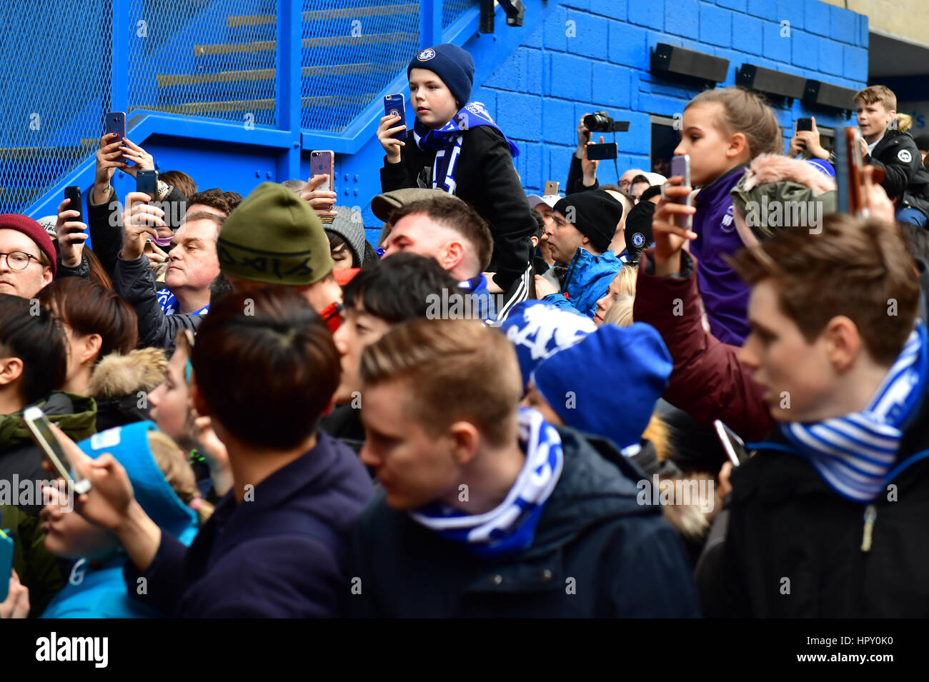 Chelsea supporters watch the arrival of the Chelsea team bus before the ...
