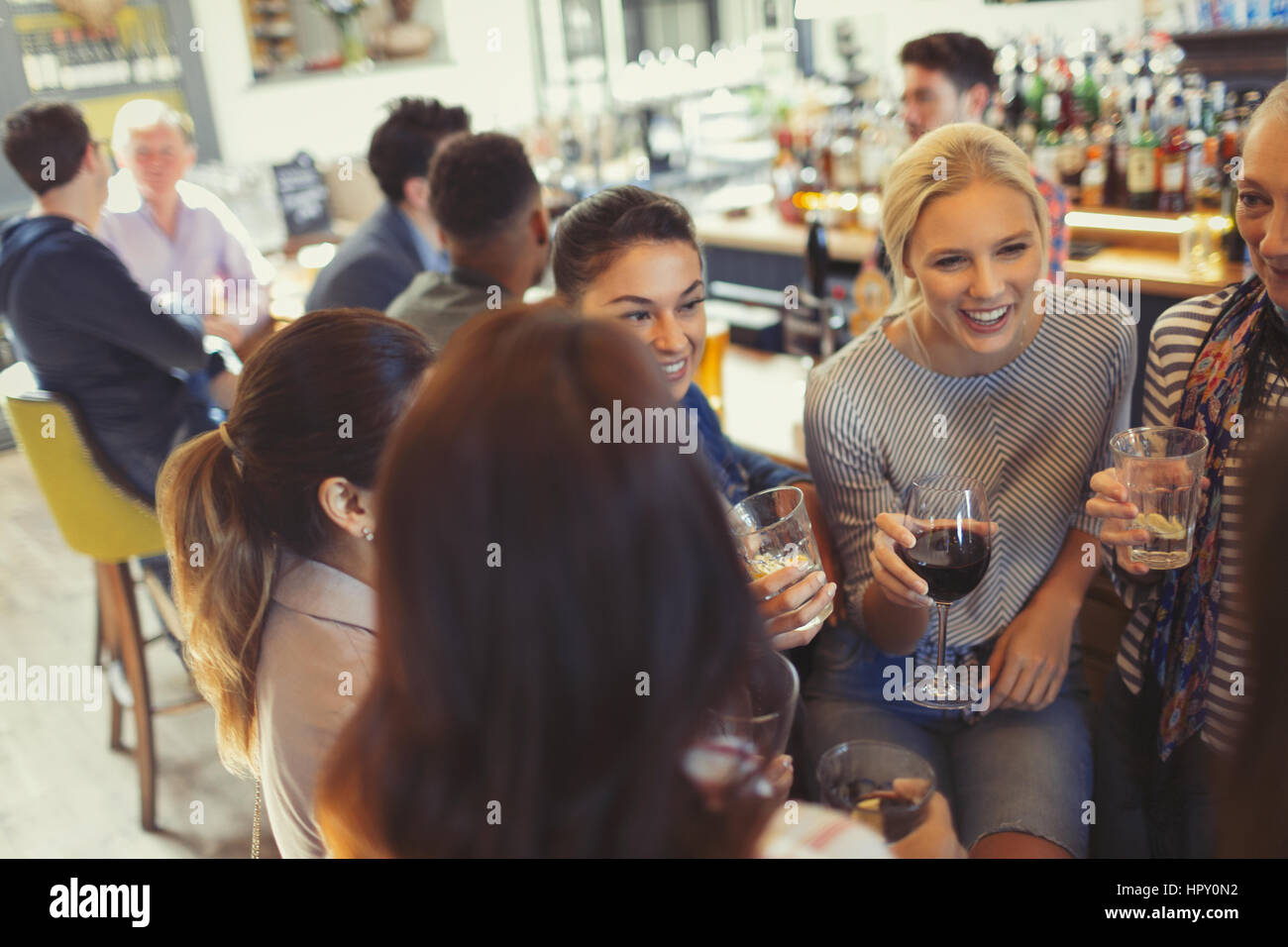 Women friends drinking and talking at bar Stock Photo - Alamy
