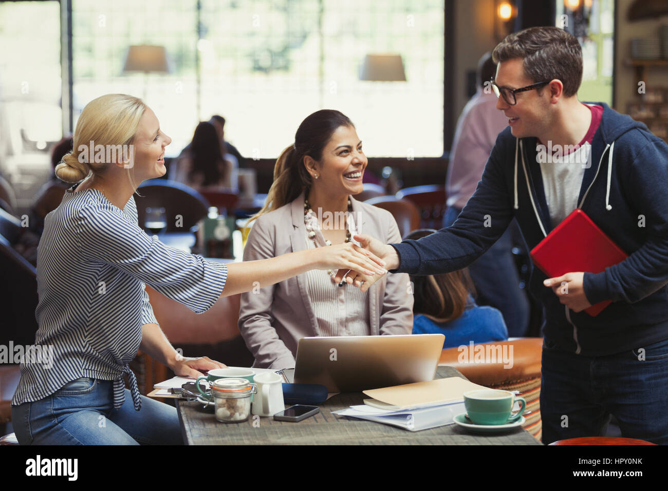 Face to face standing smiling greeting holding communication hi-res ...