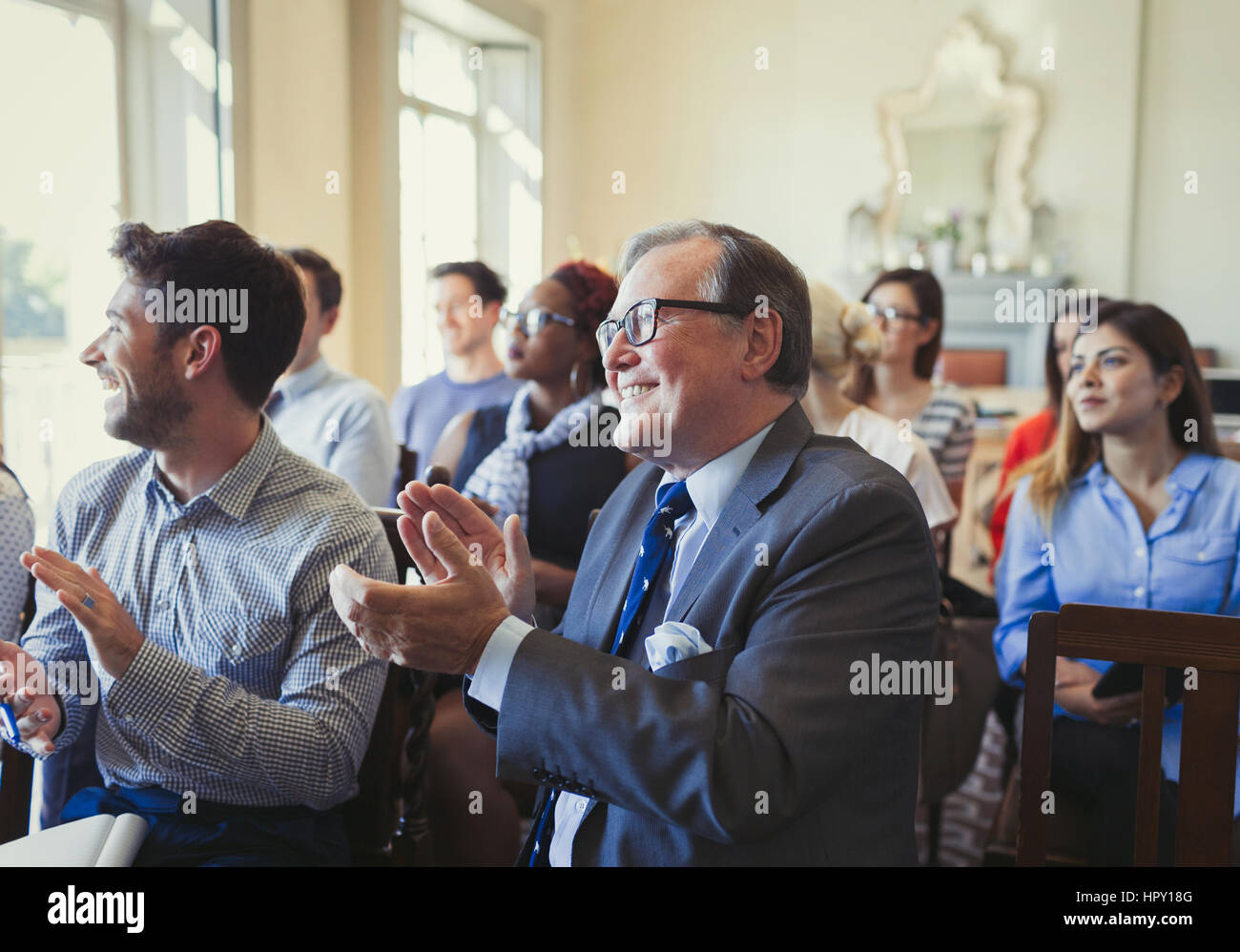 Smiling business people clapping in business conference audience Stock ...