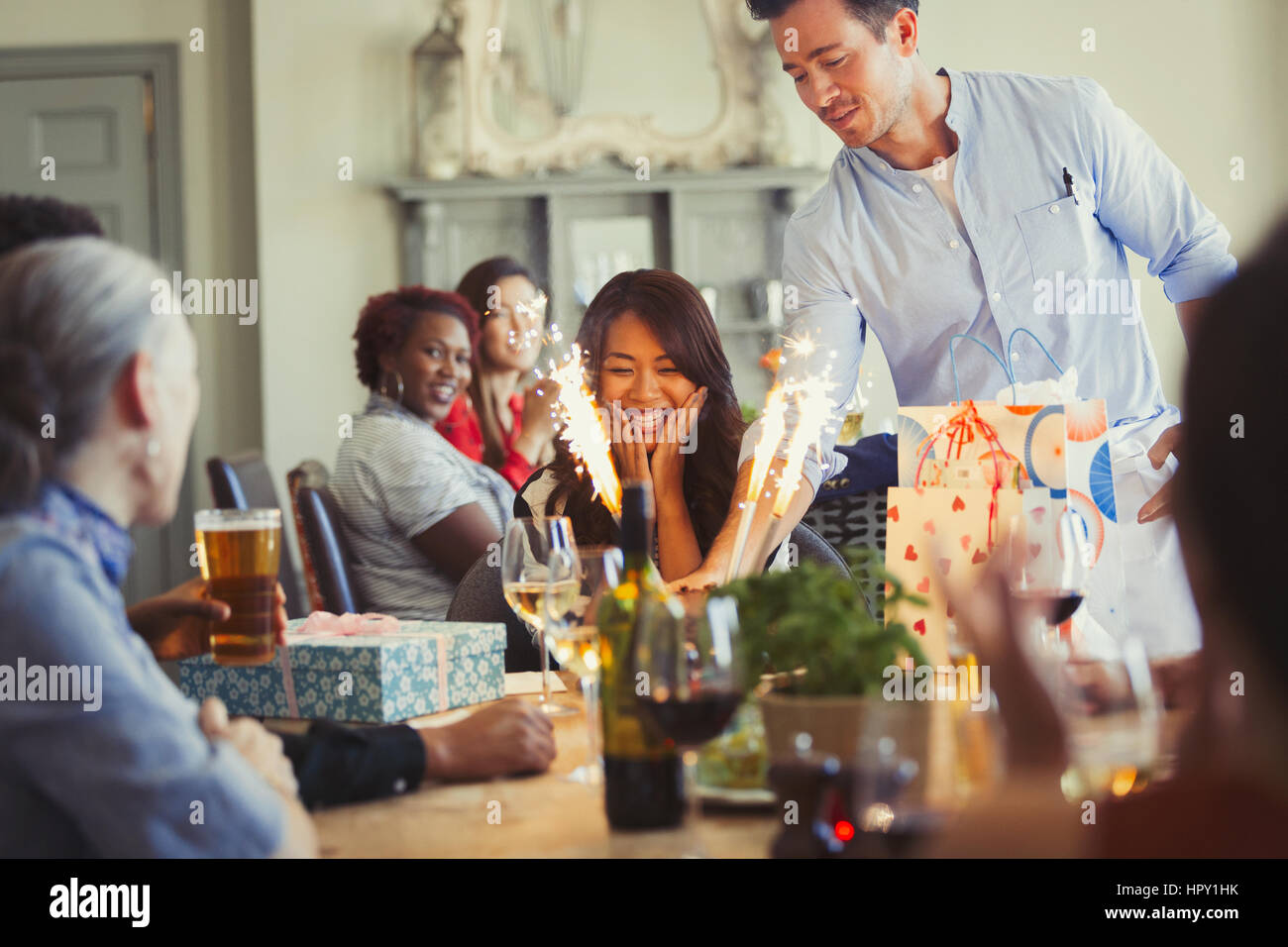Waiter serving fireworks birthday cake to happy woman at restaurant ...