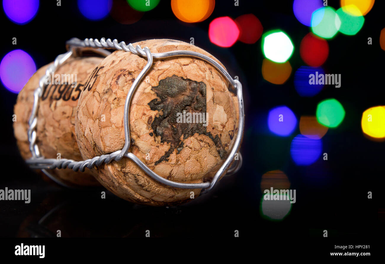 Champagne cork with the shape of Alaska burnt in and colorful blurry ...