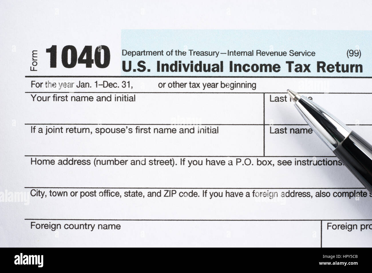 Tax return blank, calculator and pen Stock Photo - Alamy