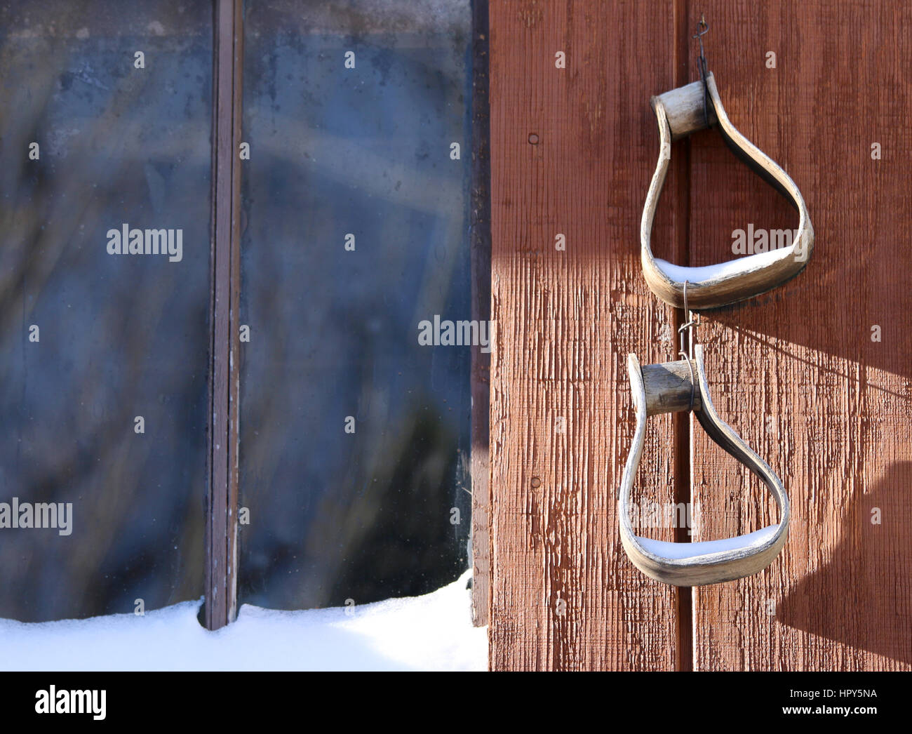 Close up of a wood shed with old stirrups Stock Photo - Alamy
