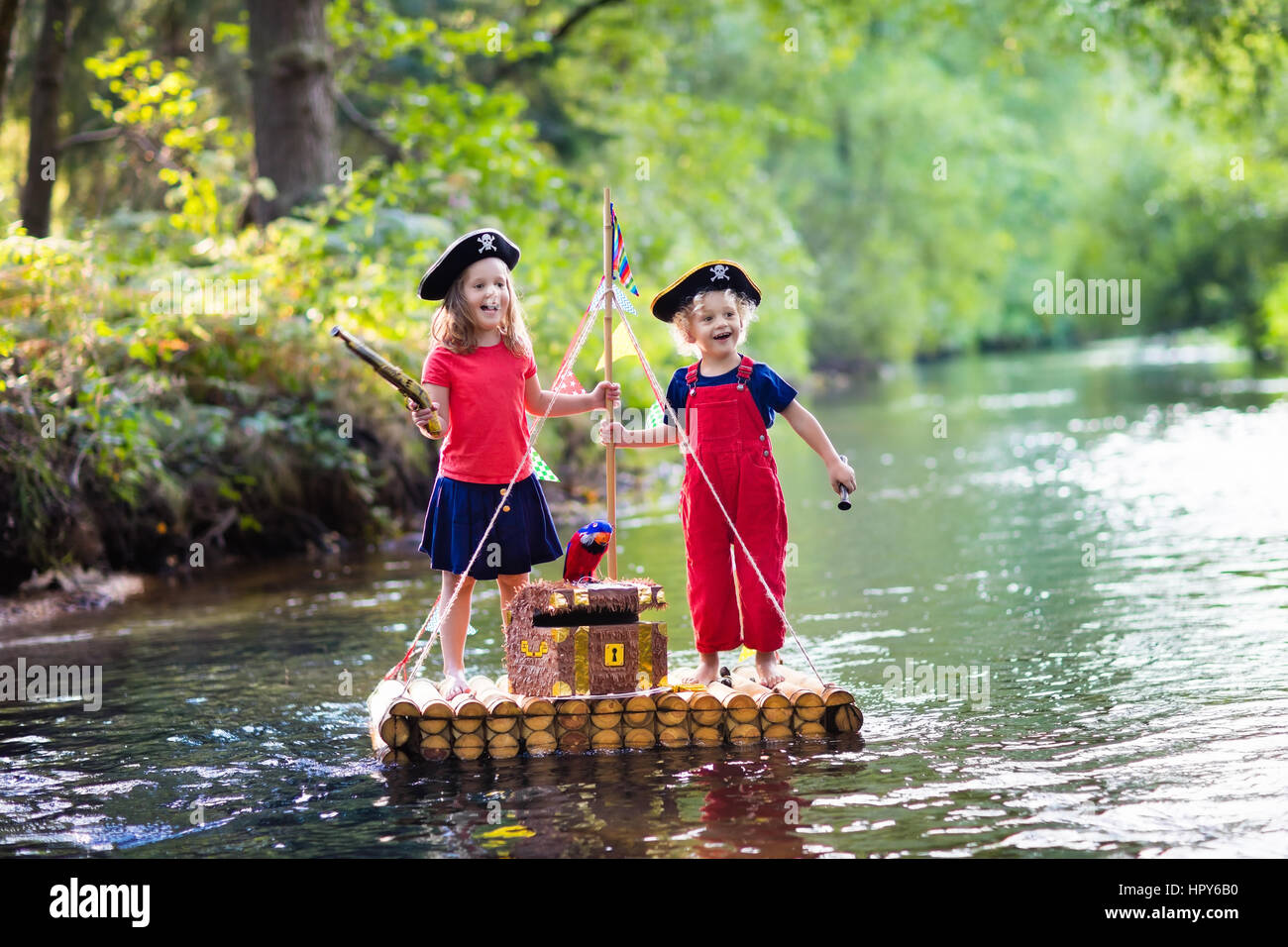 Kids dressed in pirate costumes and hats with treasure chest ...