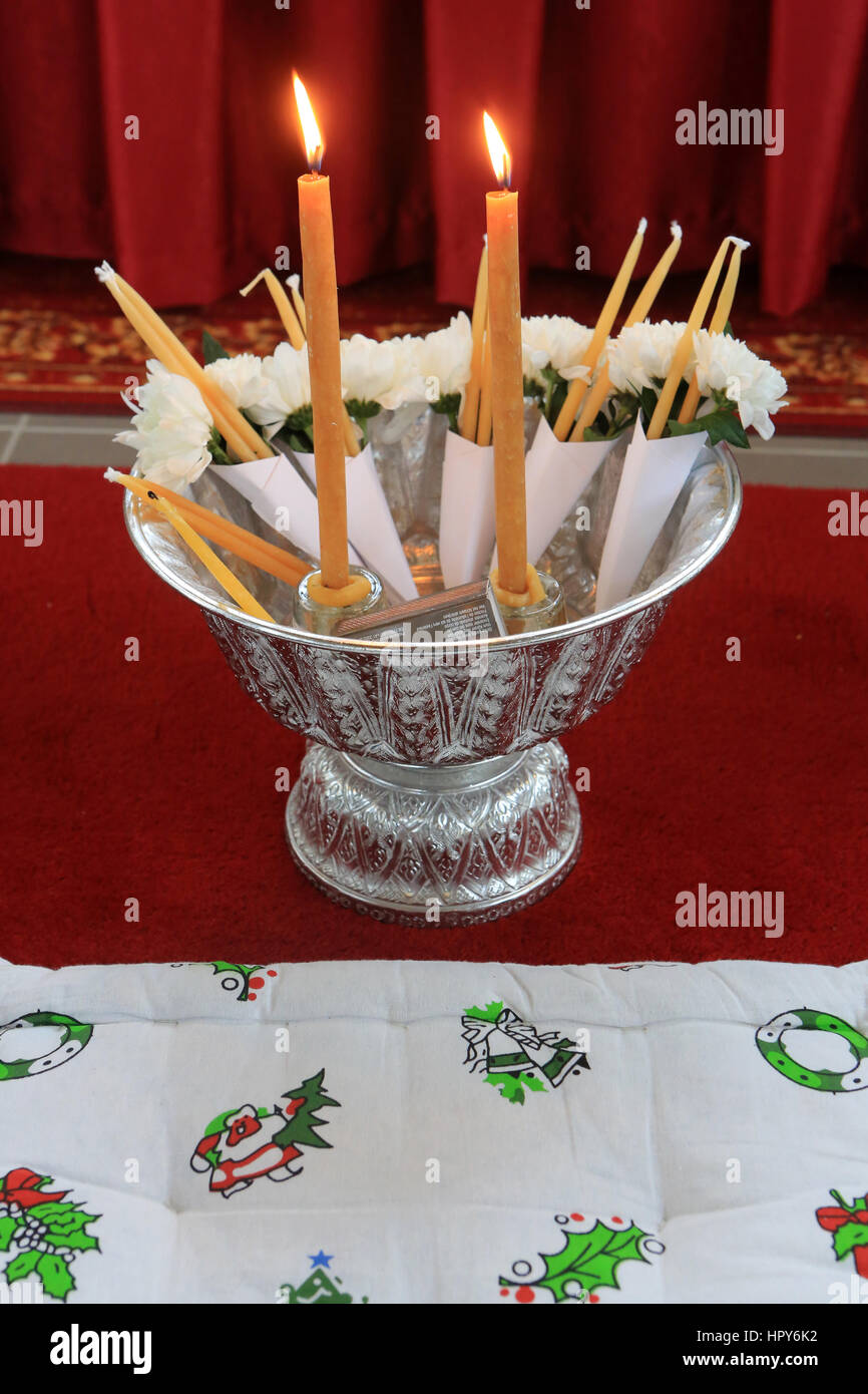 White flowers and candles. Buddhist offerings. Wat Velouvanaram ...