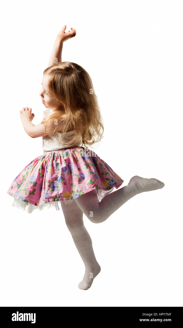 Cute three-year girl is jumping, running, dancing, laughing. Her hair ...