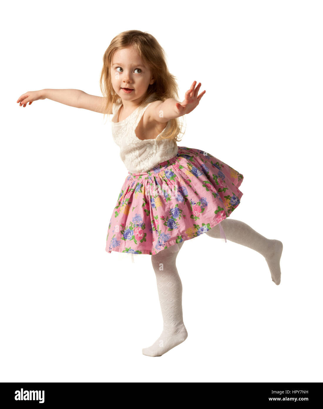Cute three-year girl is jumping, running, dancing, laughing. Her hair ...