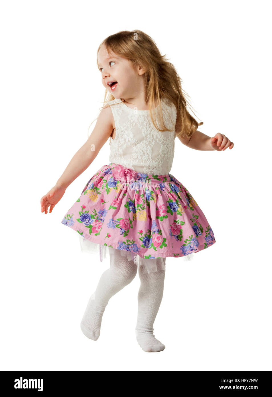Cute three-year girl is jumping, running, dancing, laughing. Her hair ...