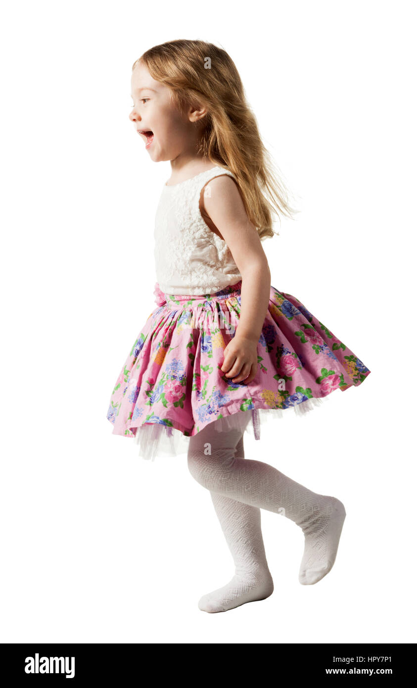 Cute three-year girl is jumping, running, dancing, laughing. Her hair ...